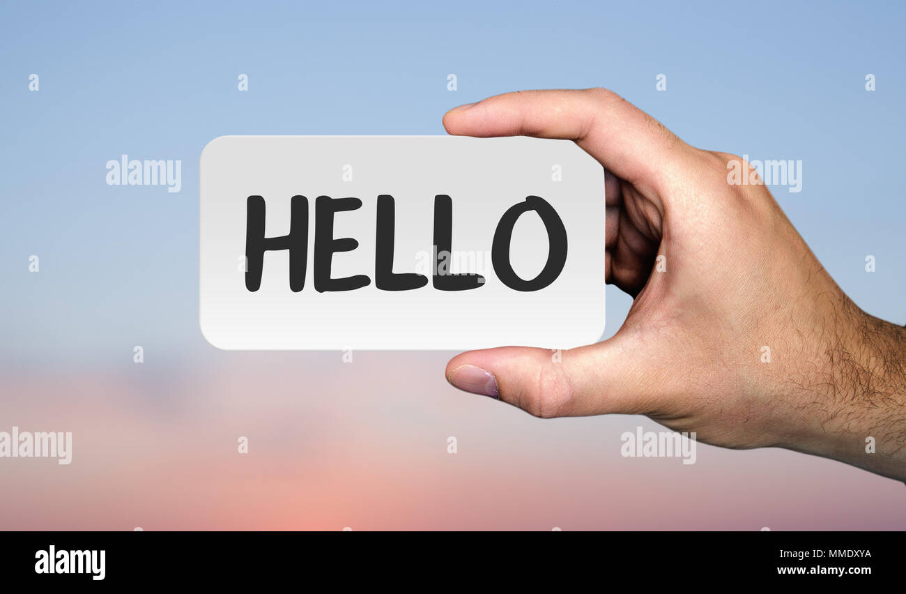Hand holding placard with word HELLO. Communication concept. Photo ...