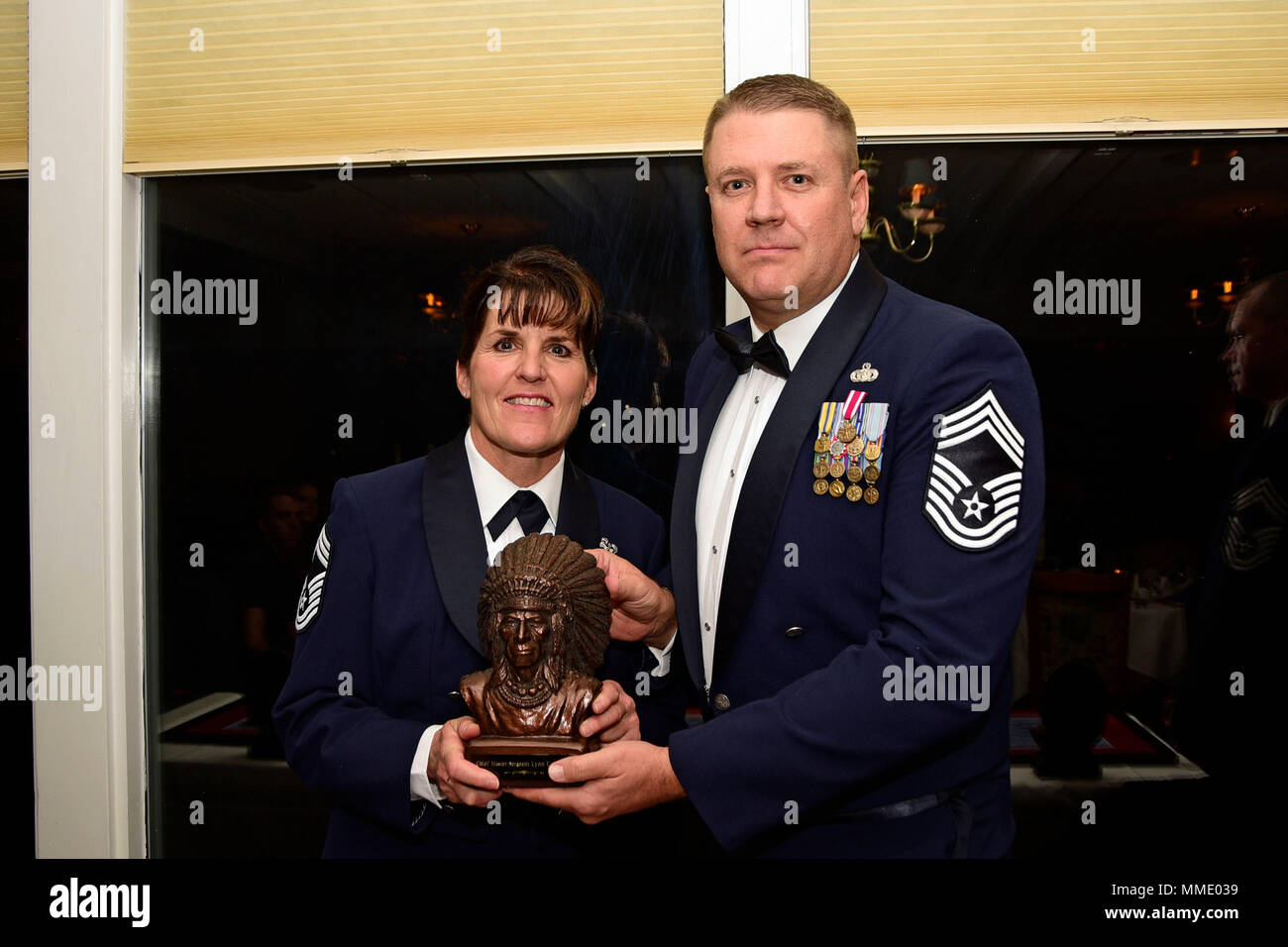 Chief Master Sgt. Dale Gunter presents a sculpture to Chief Master Sgt ...