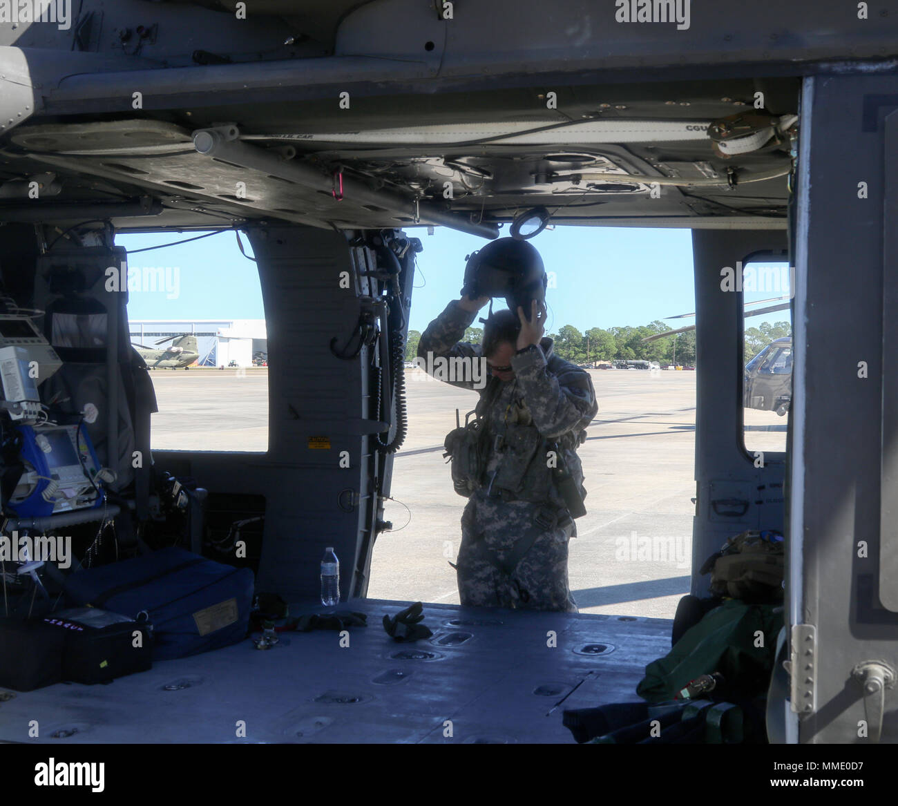 A crew chief with the 1st Battalion, 168th Aviation Regiment, secures ...