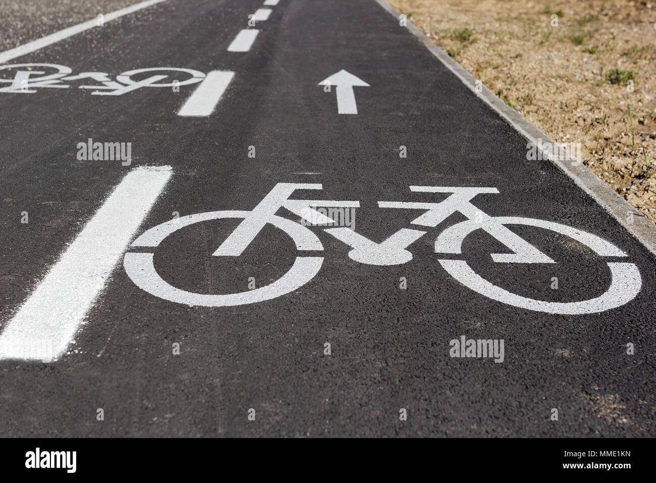 Bicycle lane with big white painted bike sign Stock Photo - Alamy