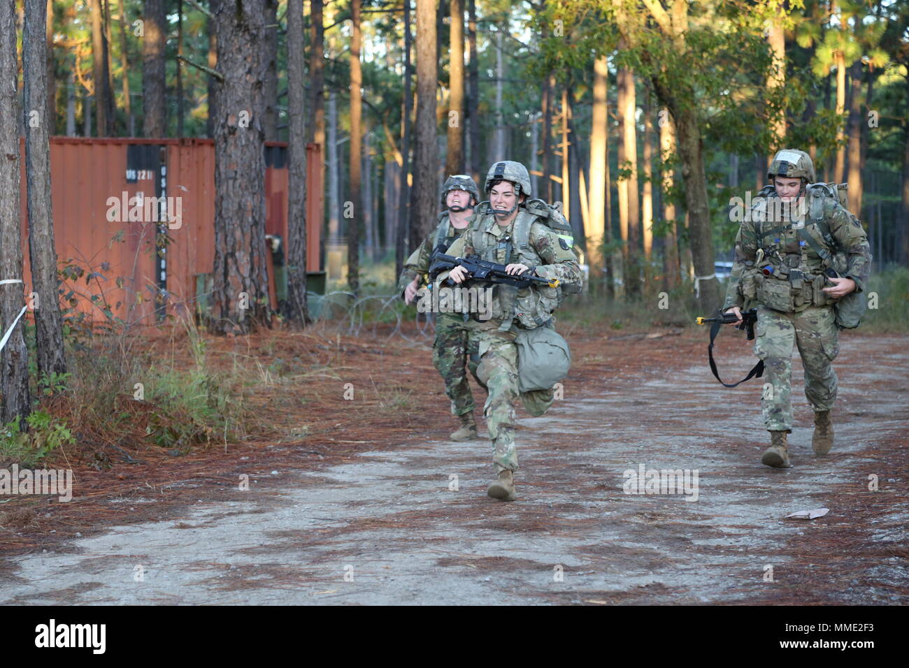 U.S. Army Soldier, crosses the finish line for the 12 mile ruck march ...