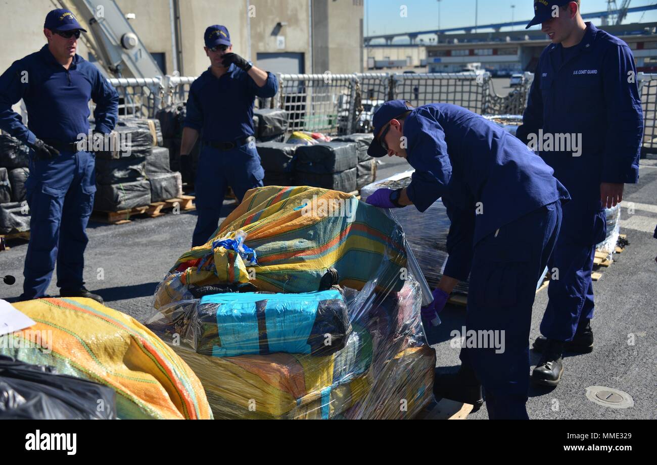 The crew of the Coast Guard Cutter Active wraps pallets of cocaine in ...