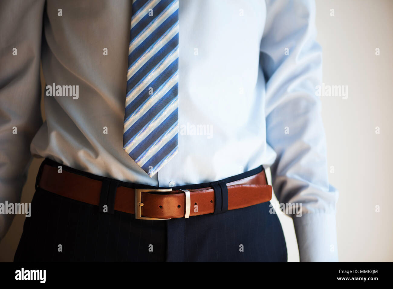 Man wears belt. Young businessman in casual suit with accessories ...