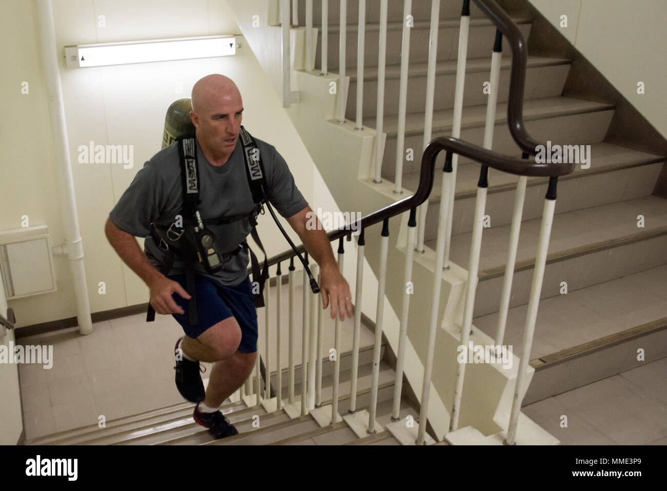 Col. Kenneth Moss, 374th Airlift Wing commander, runs up a flight of ...