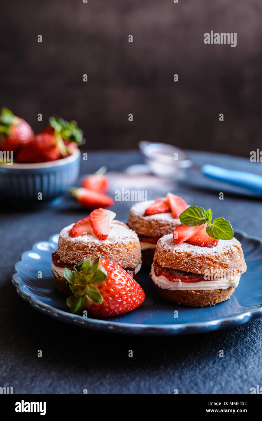 Traditional mini Victoria sponge cakes with whipped cream and ...