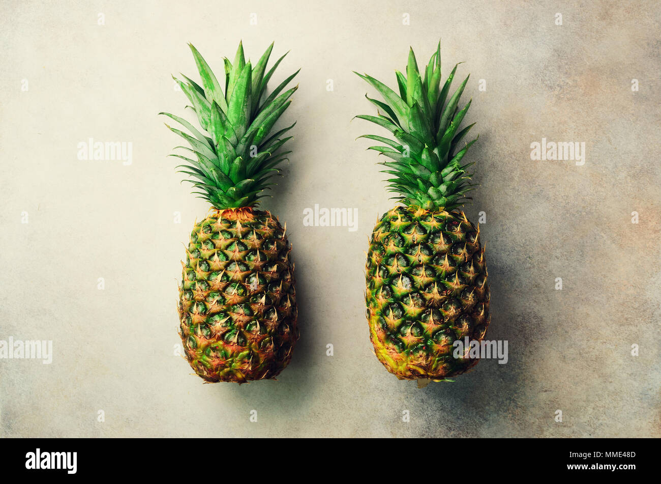 Two pineapples on gray background, top view, copy space. Minimal design ...