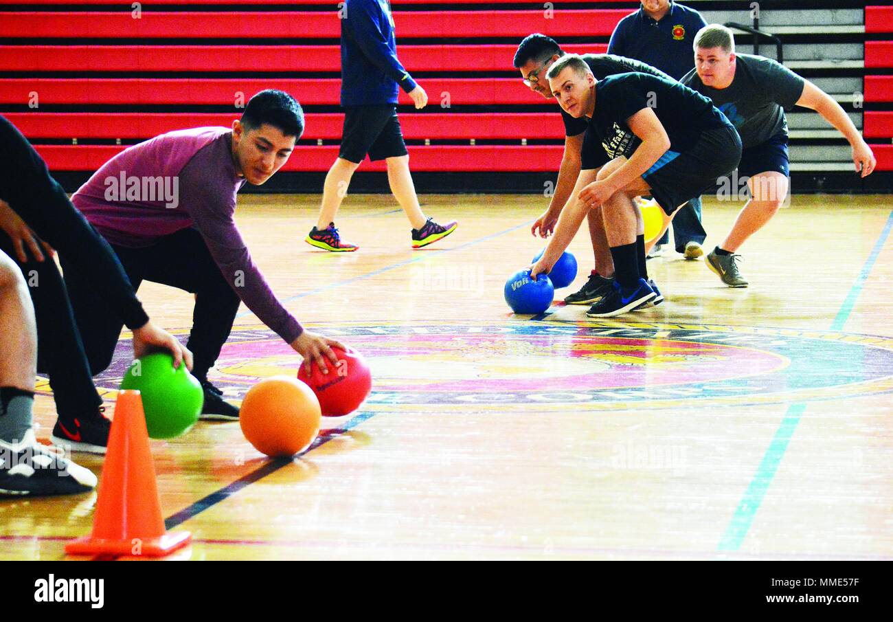 The game is on as Marines sprint to the middle of the court to grab ...