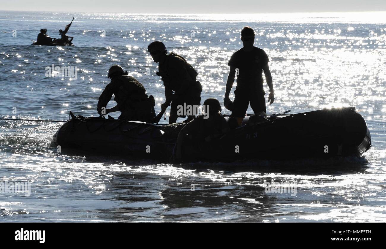 Explosive Ordnance Disposal Mobile Unit One divers retrieve a mine ...