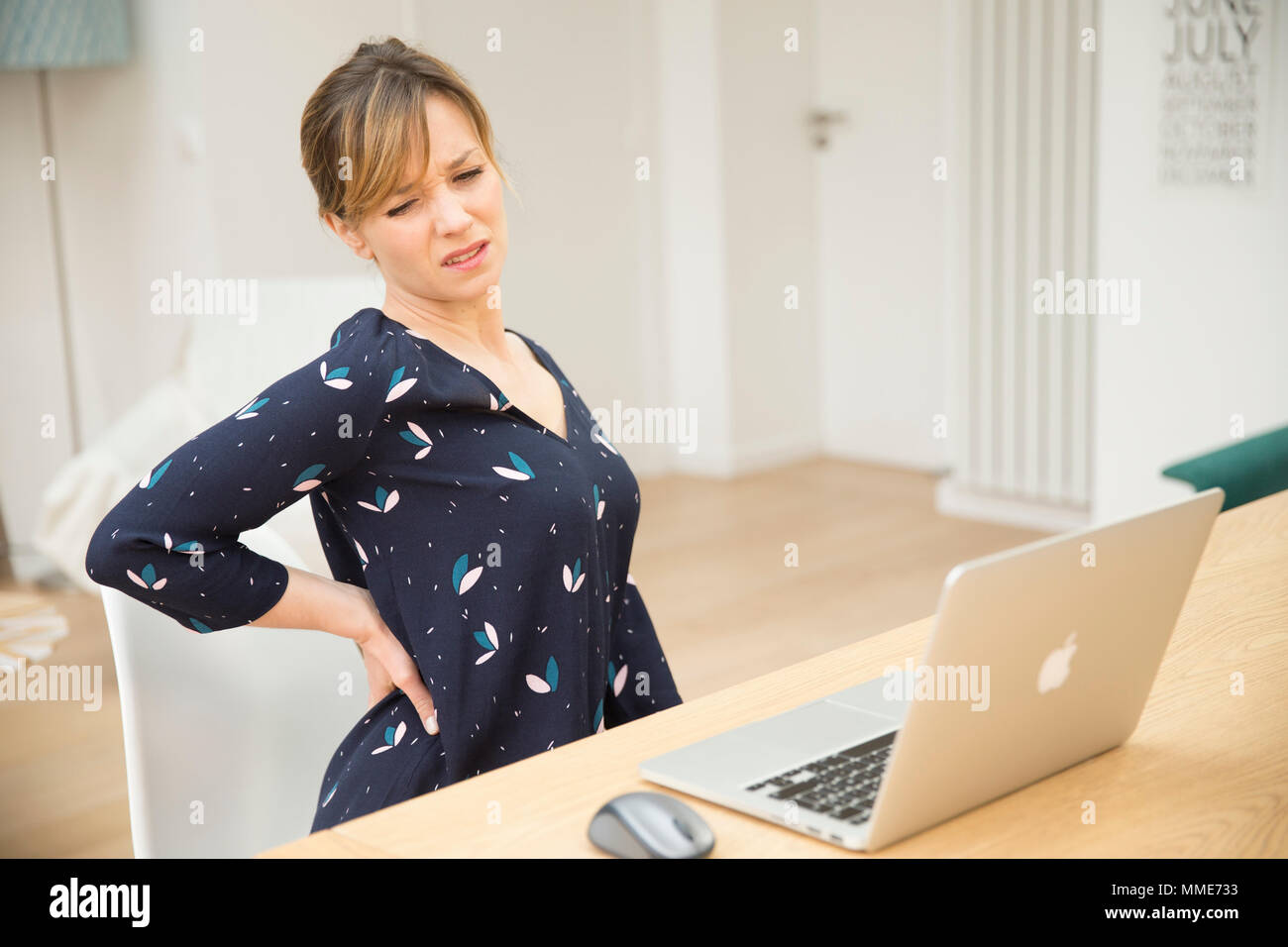 Woman back pain desk hi-res stock photography and images - Alamy