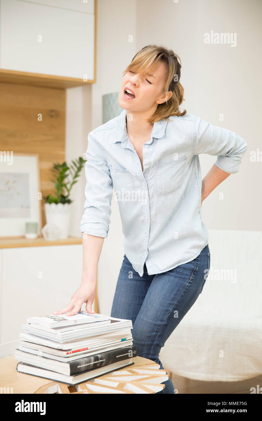 WOMAN WITH LOWER BACK PAIN Stock Photo - Alamy