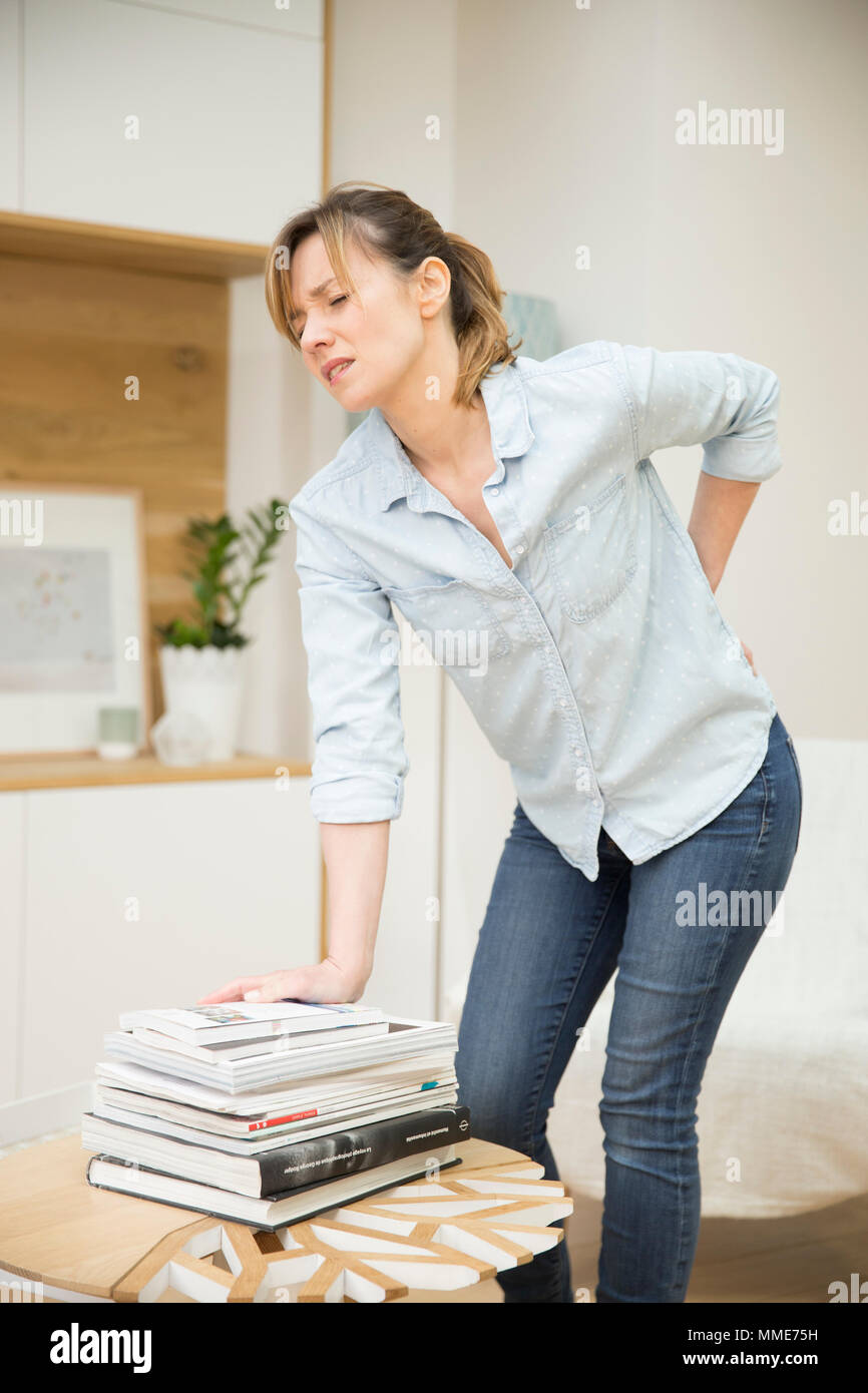 WOMAN WITH LOWER BACK PAIN Stock Photo - Alamy