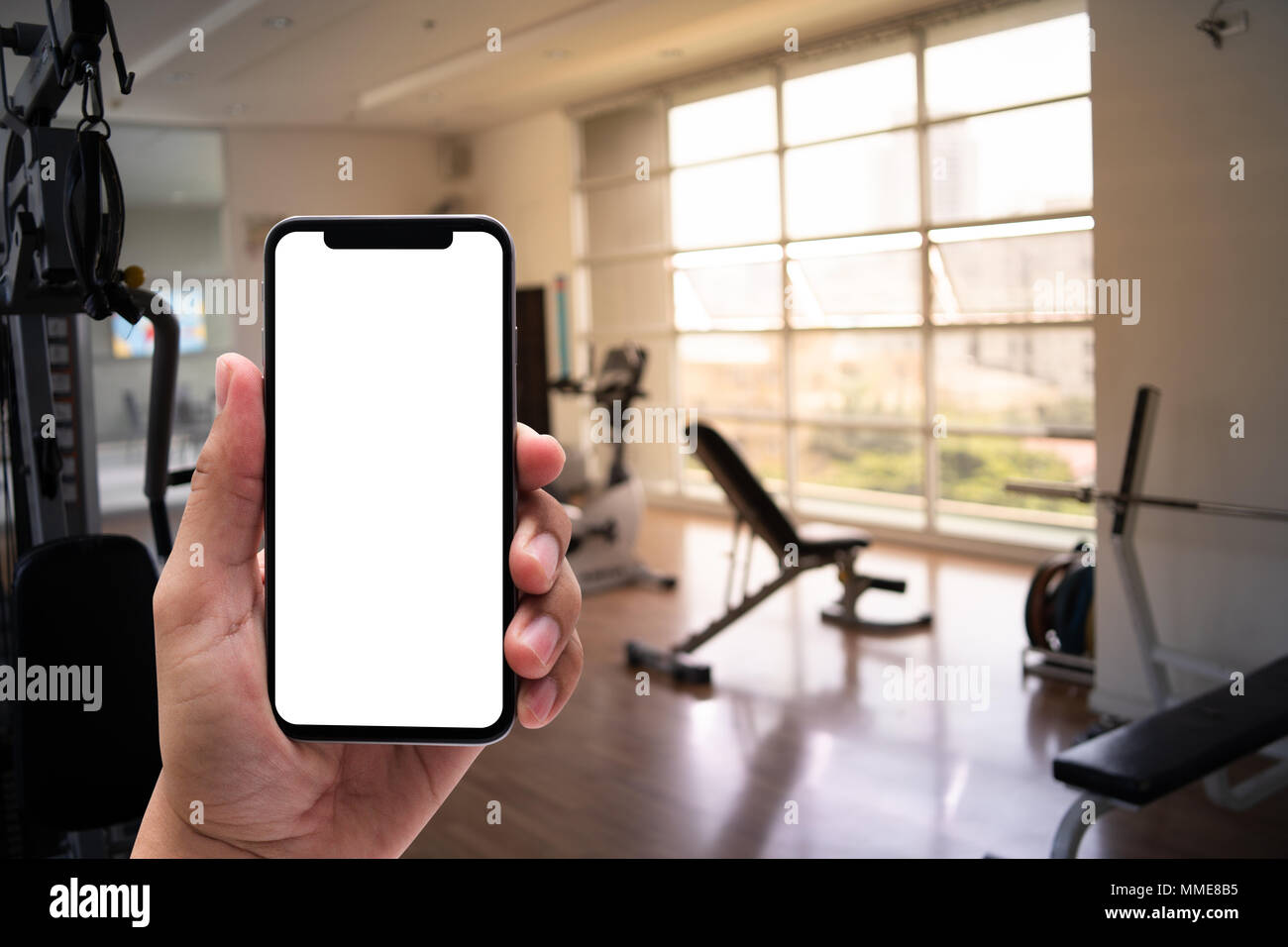 Young man Hand holding smartphone in gym to fitness phone fitness ...