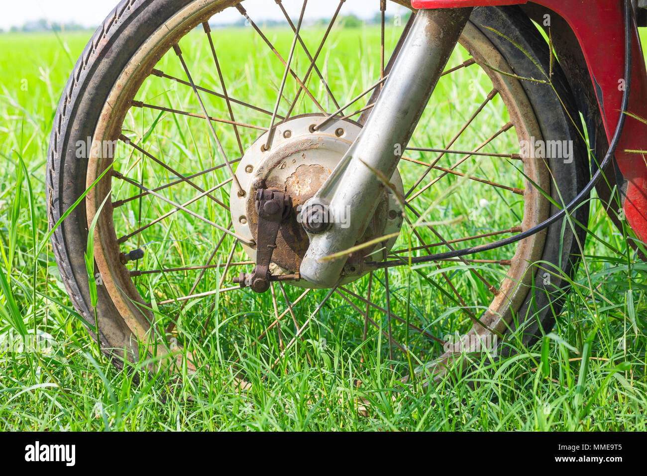 wheel of abandonned motorbike with drum break Stock Photo - Alamy
