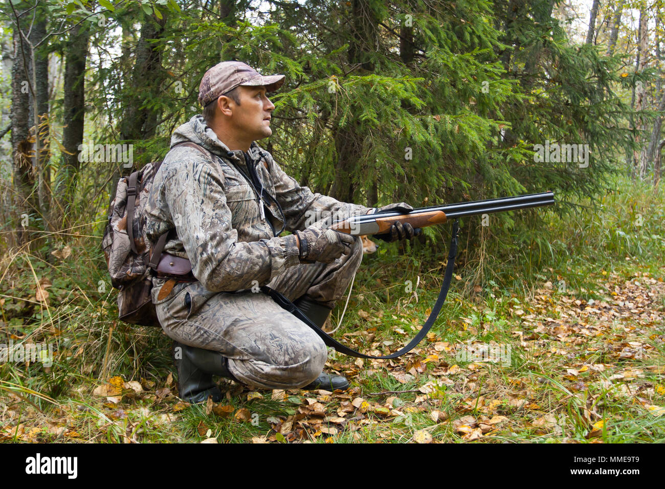 hunter waiting a prey in the forest Stock Photo - Alamy