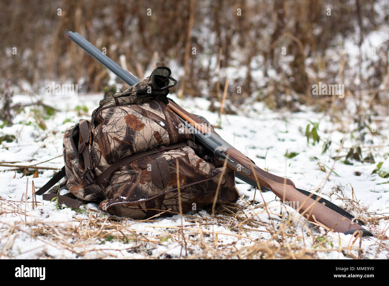 hunting gun and backpack on the snow Stock Photo - Alamy