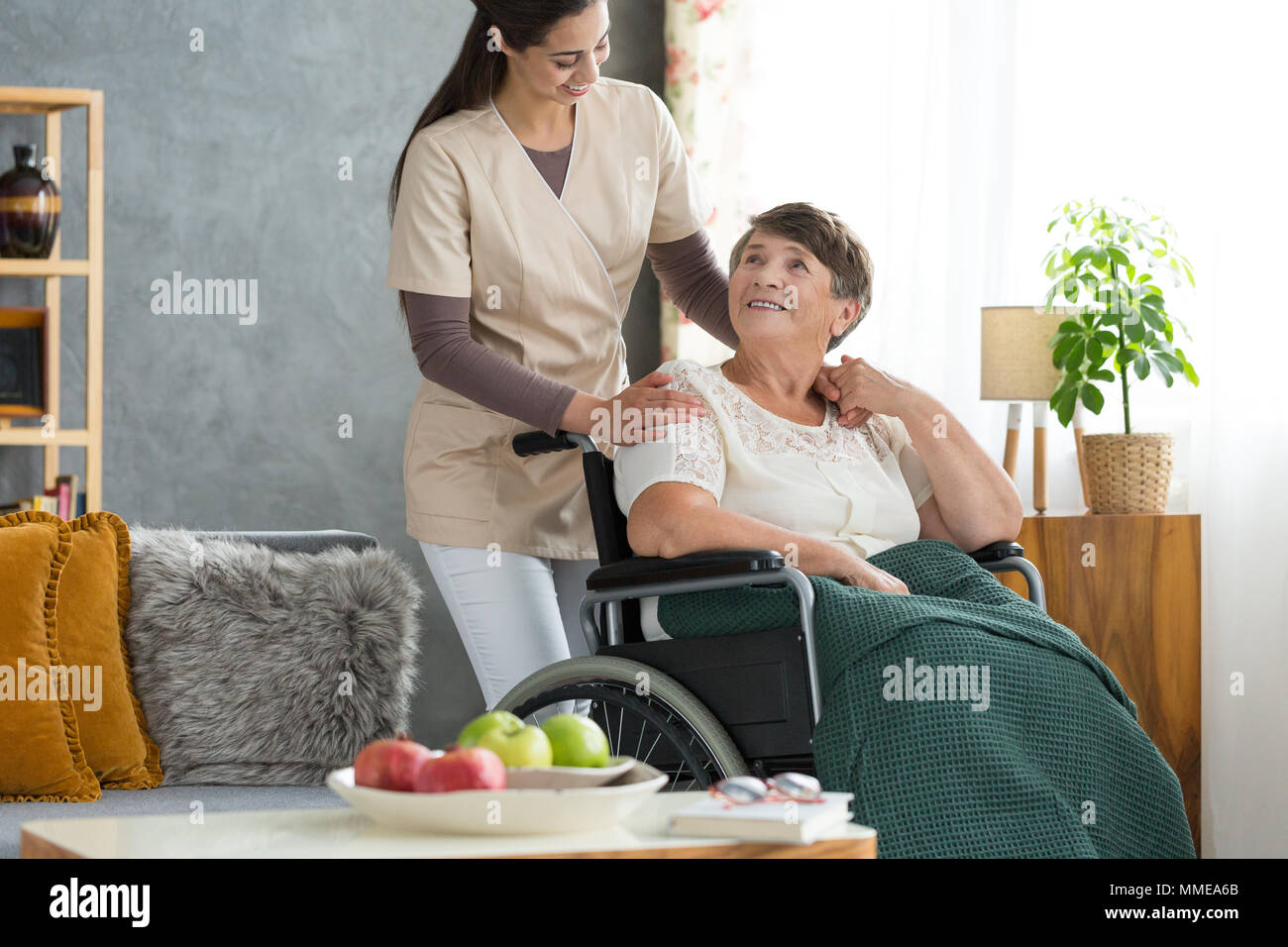 Young medical school intern visiting her elder patient at home after ...