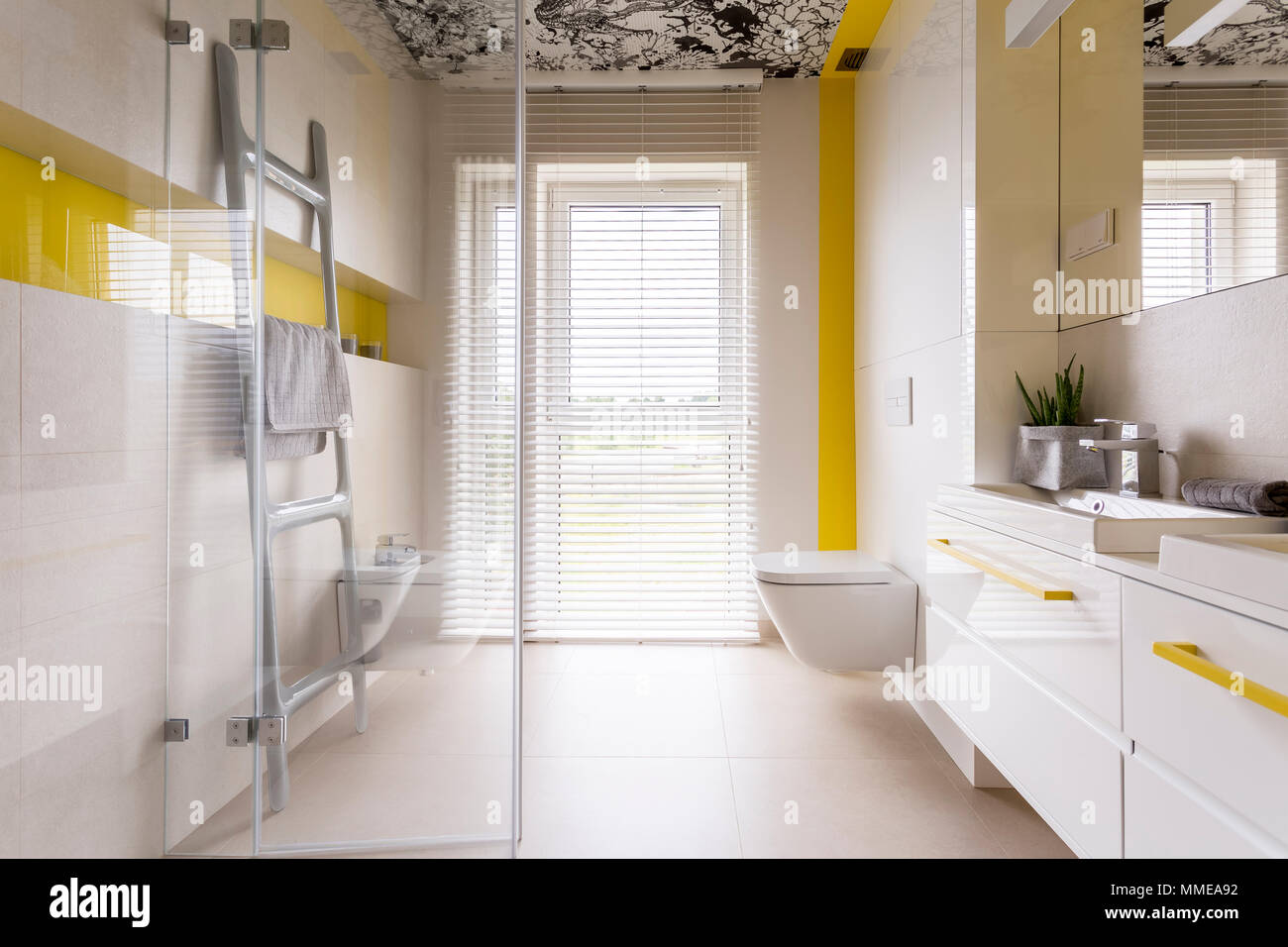 Luxury stylish bathroom with white cabinets, mirror, ladder tower rack ...