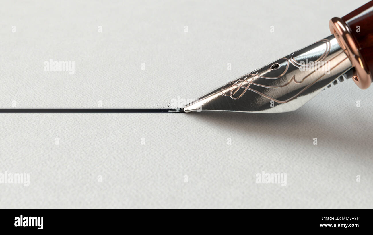 A closeup view of an ornate metal nib of an old fountain pen drawing a ...