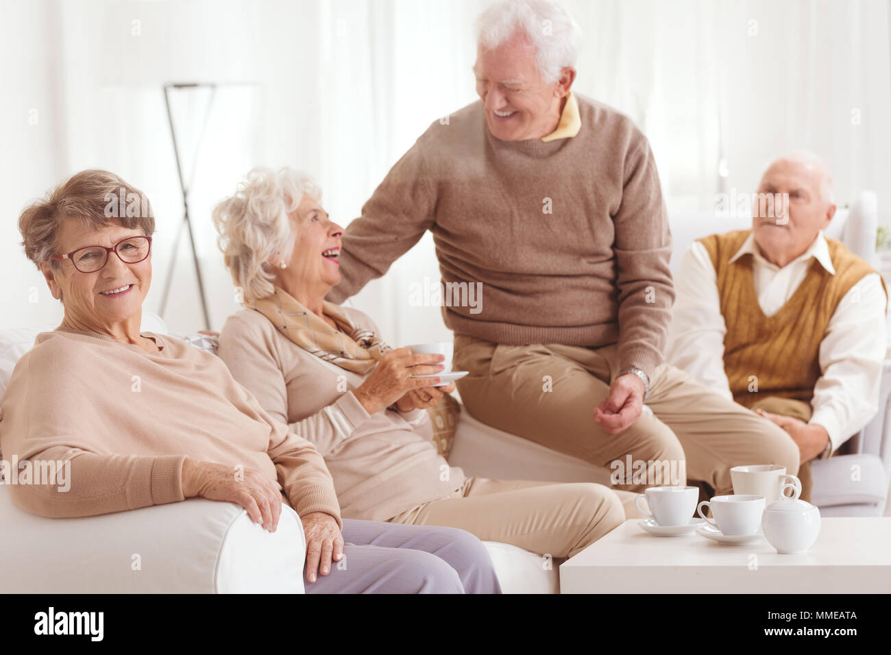 Happy retired people spending time together, talking and smiling Stock ...