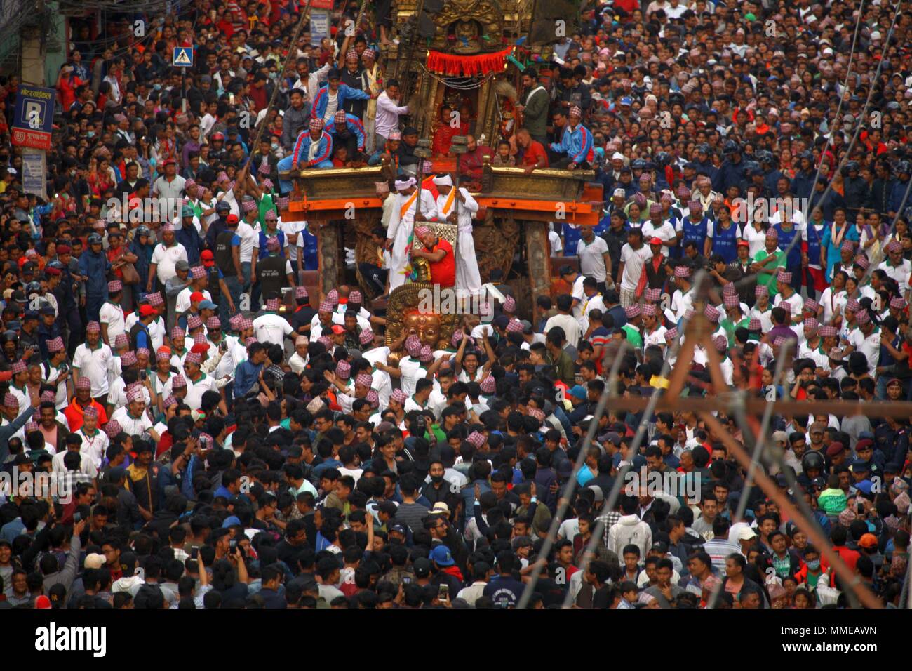 People participate in the chariot procession in celebration of a month ...