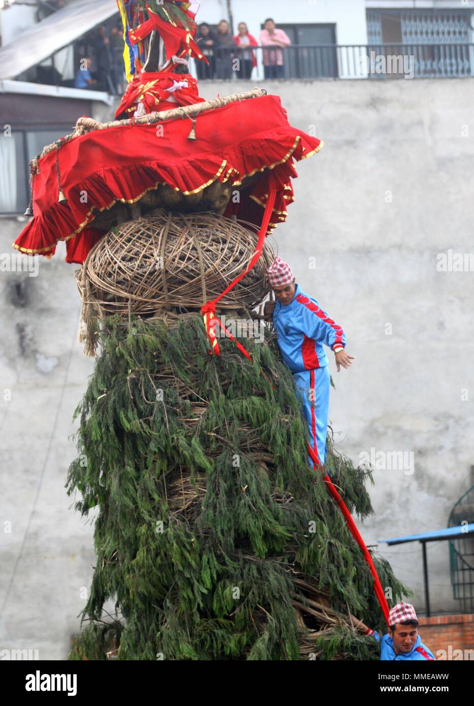 People participate in the chariot procession in celebration of a month ...
