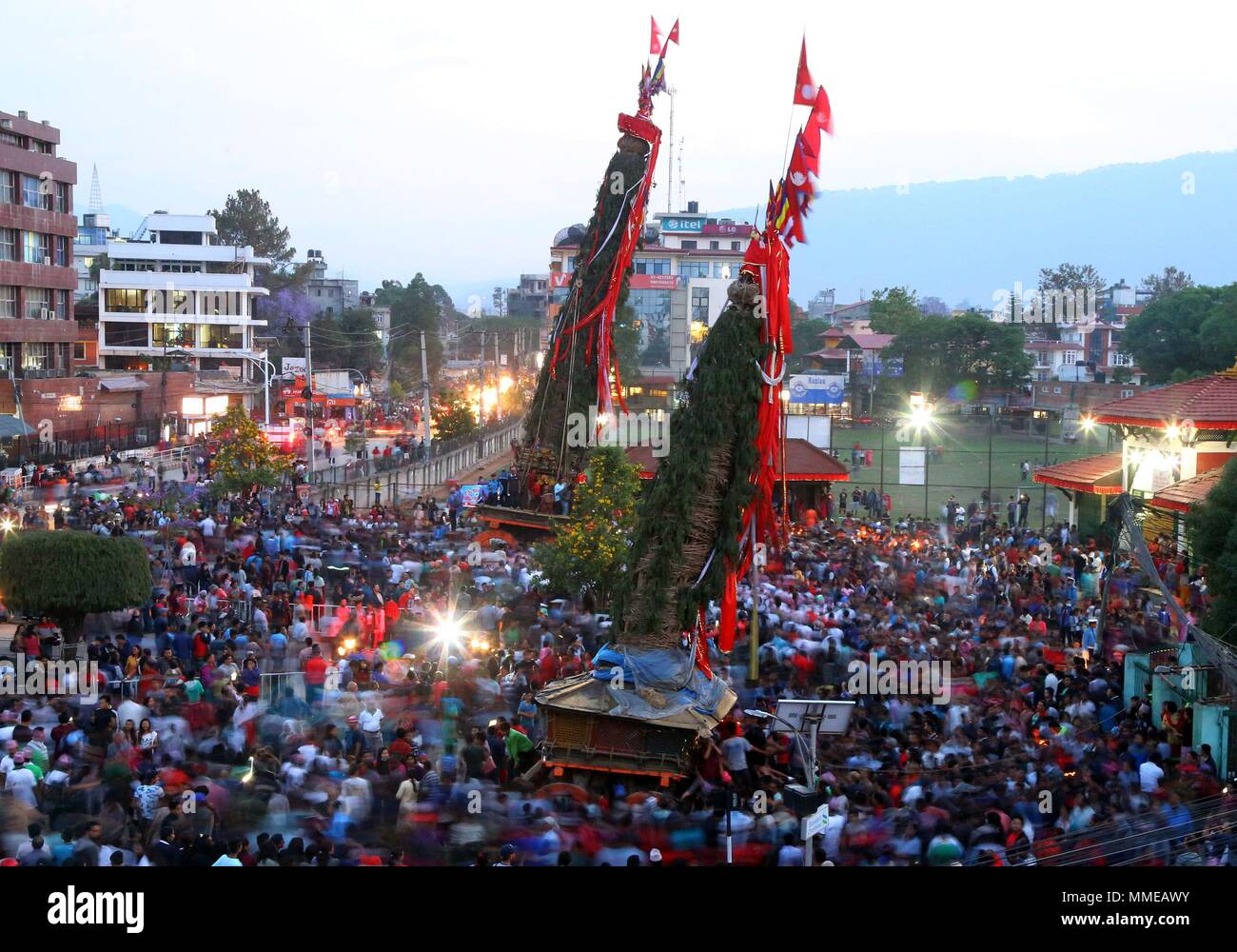 People participate in the chariot procession in celebration of a month ...