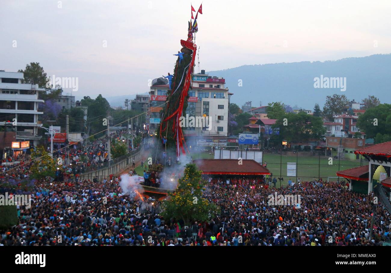 People participate in the chariot procession in celebration of a month ...