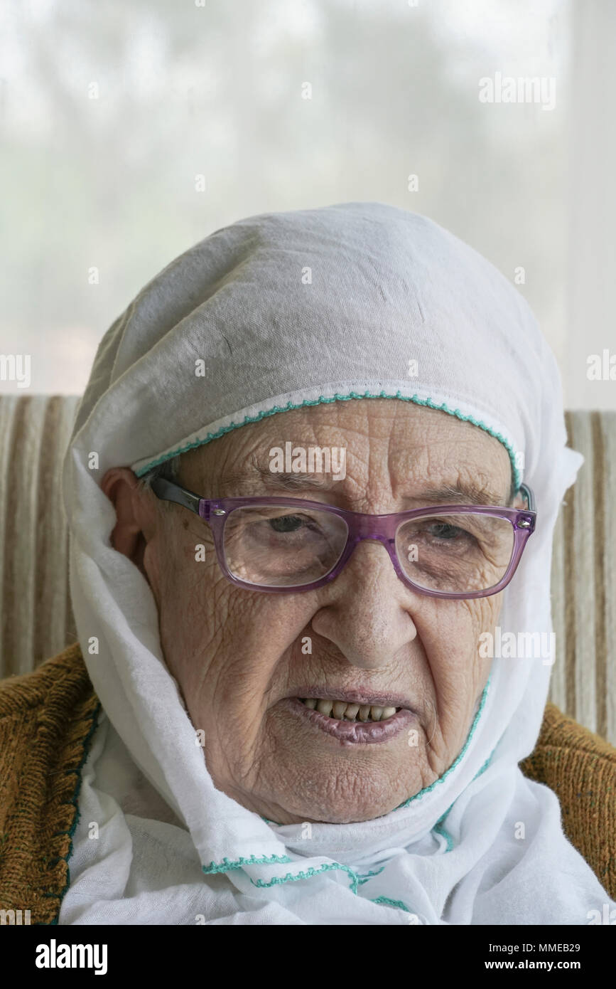 A senior woman wearing white headscarf Stock Photo - Alamy