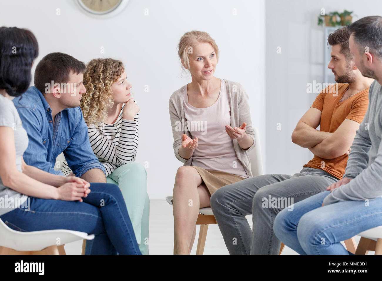 Psychologist encouraging her patients to open up at group meeting Stock ...