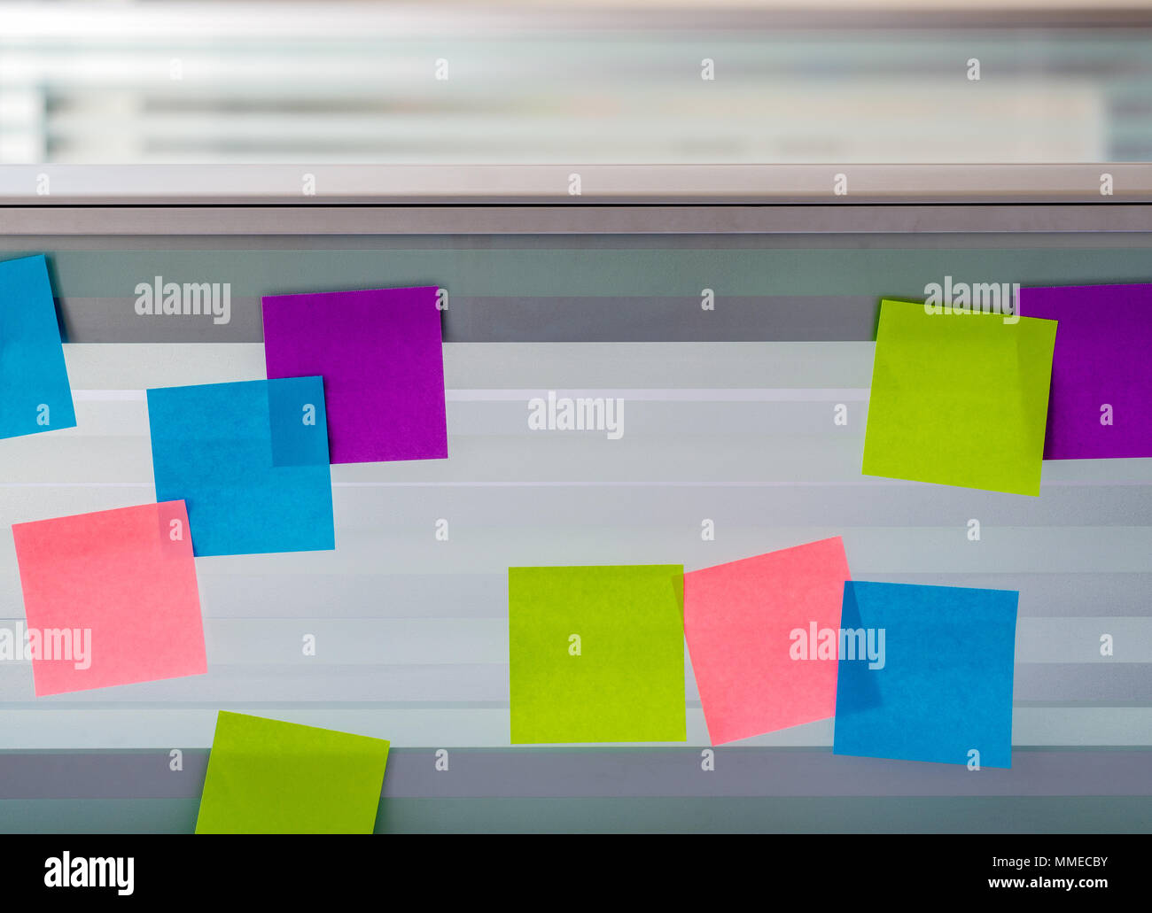 Randomly scattered blank colored sticky notes over glass screen of a ...