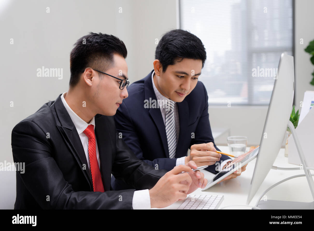 Salesman explaining his idea of overcoming crisis to co-worker Stock ...