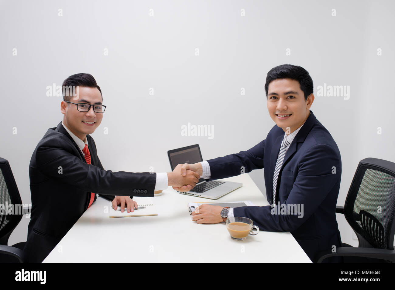 Two men handshake in the office Stock Photo - Alamy