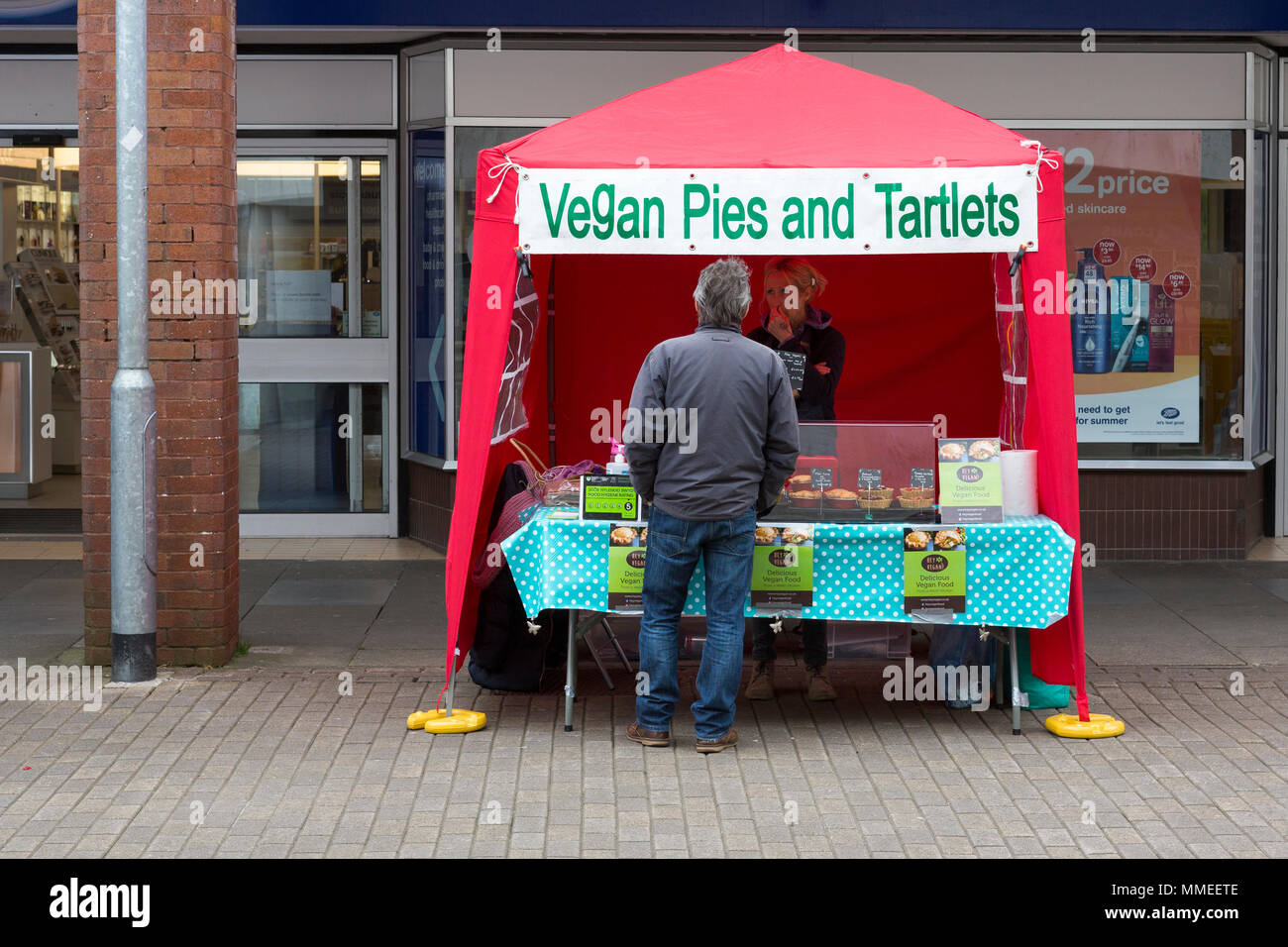 Vegan food stall in a street in UK serving a customer Stock Photo - Alamy