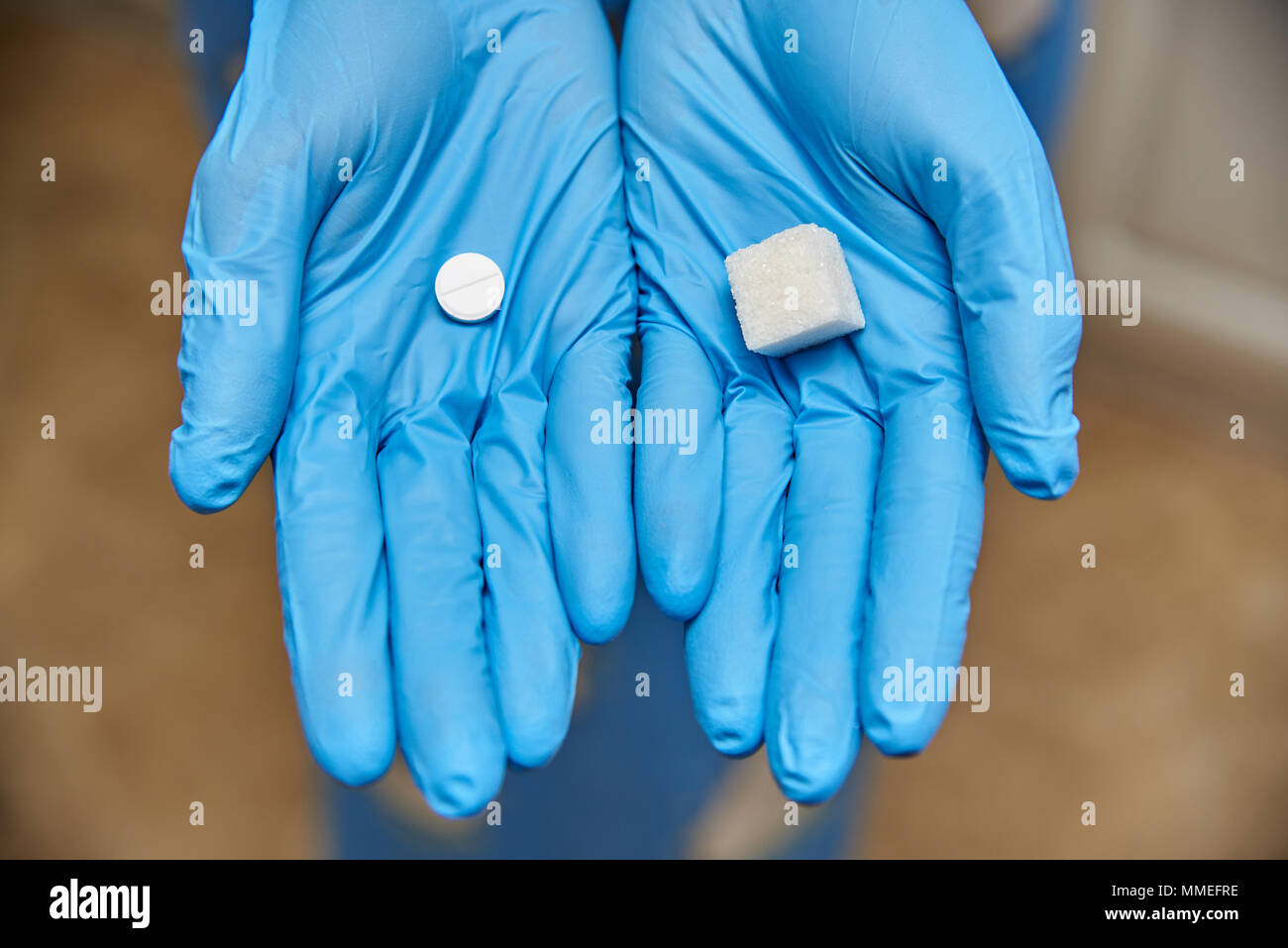 Hands in rubber gloves hold sugar and a tablet Stock Photo - Alamy