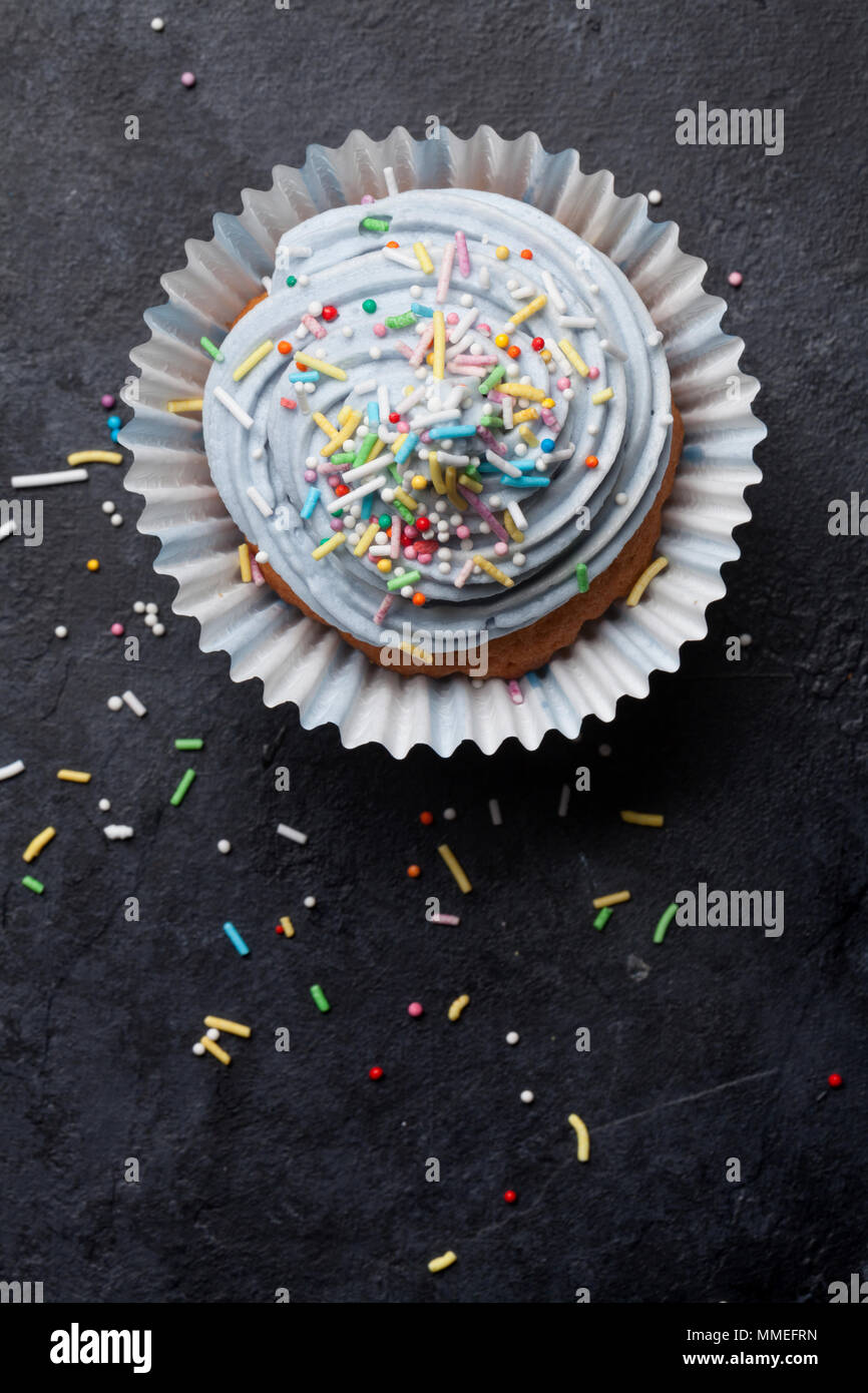 Sweet cupcake with colorful decor. Top view Stock Photo - Alamy