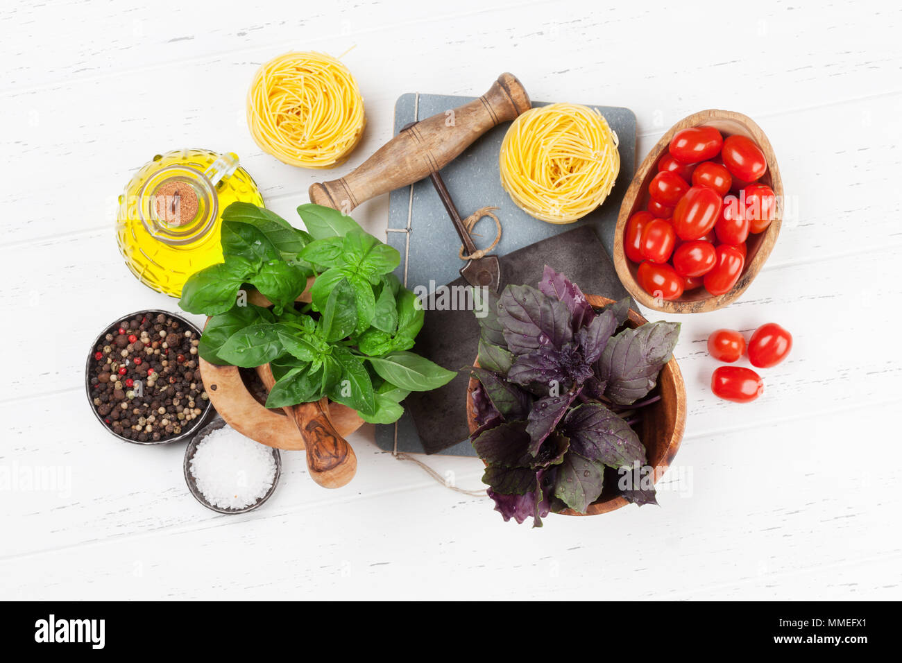 Italian cuisine. Basil, pasta and tomato cooking. Top view Stock Photo ...