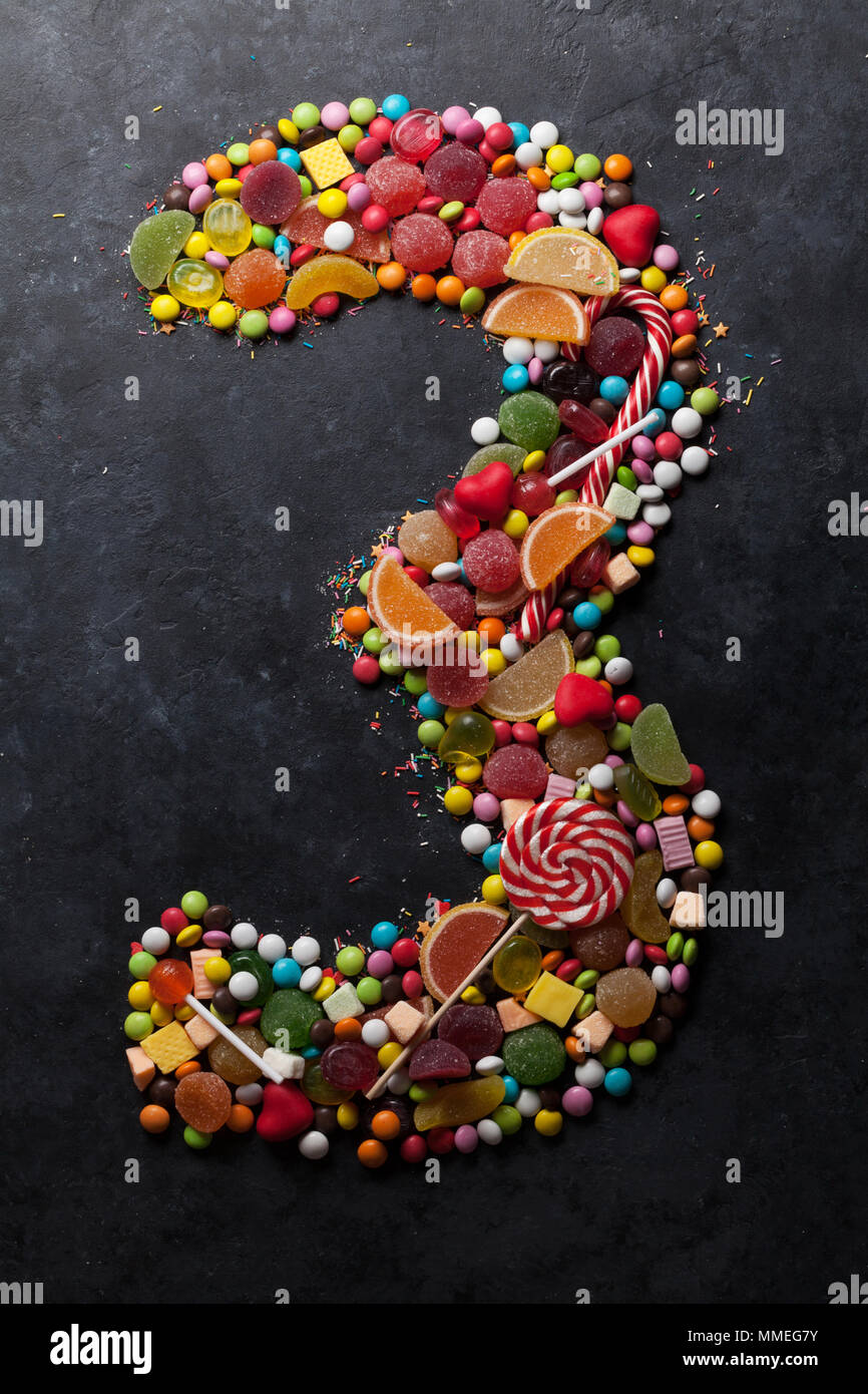 Number three made from sweet candies on dark background. Greeting card ...