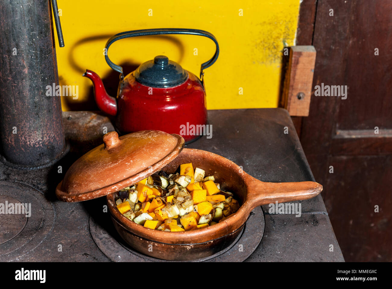 Old firewood kitchen where they are cooking a meal, the fire is visible ...