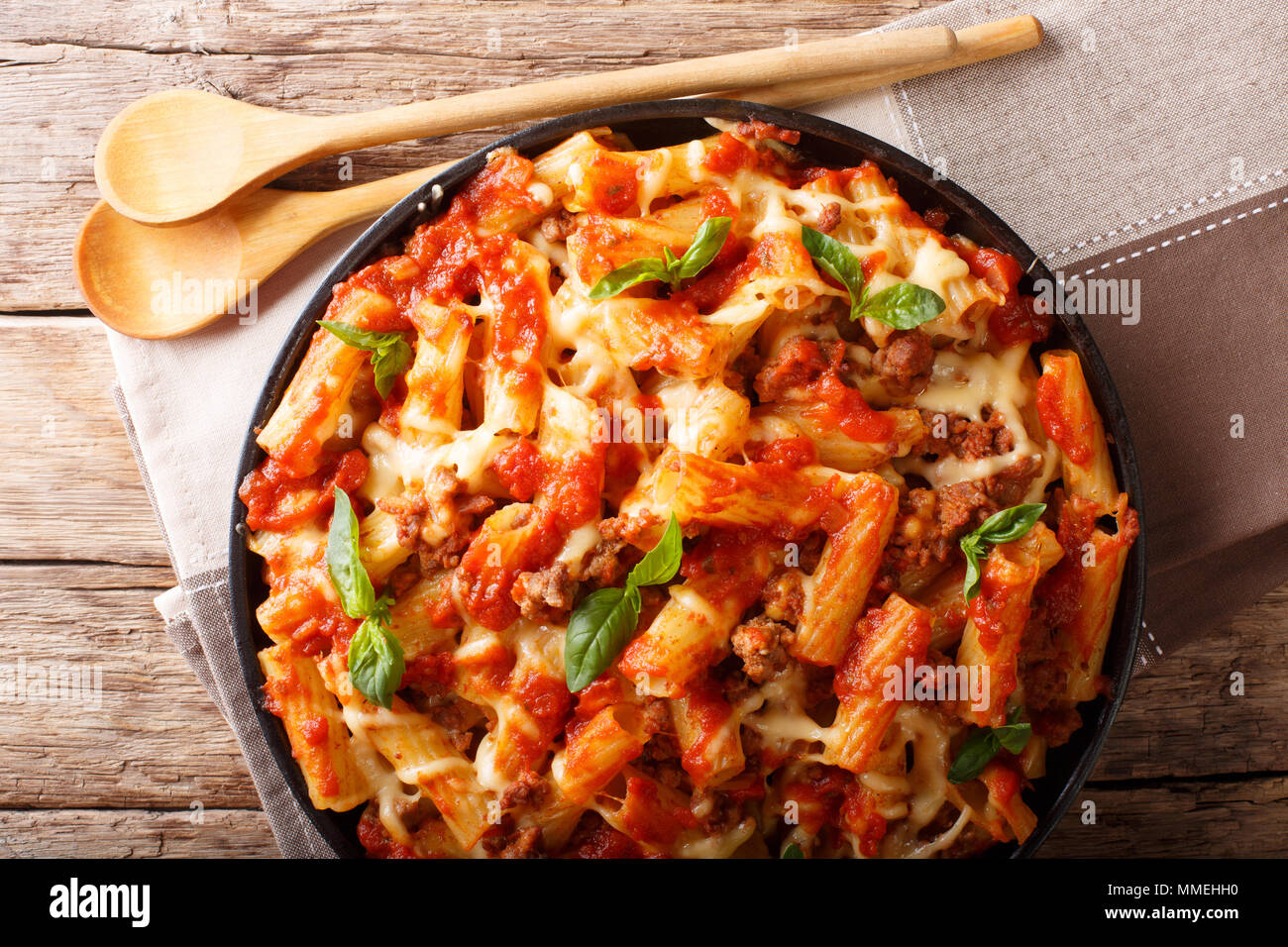 Delicious pasta with ground beef, tomatoes and cheese close-up on a ...