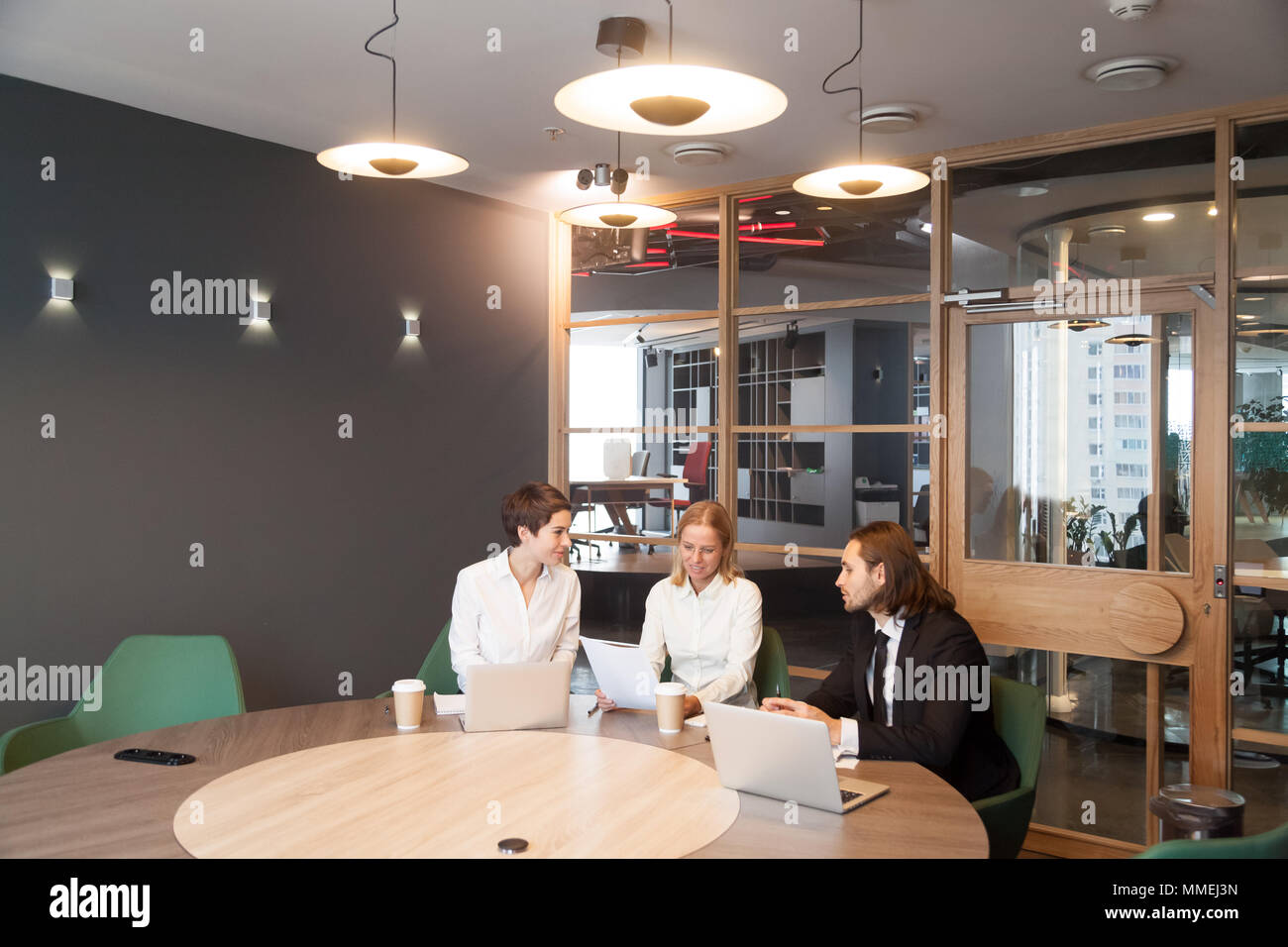 Businesspeople having discussion at team meeting in modern offic Stock ...