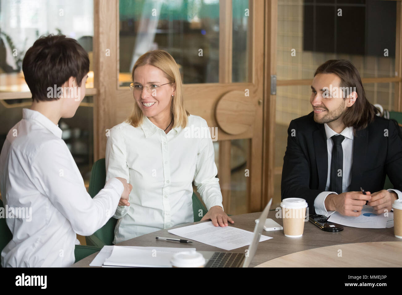 Office workers shaking hands business agreement hi-res stock ...