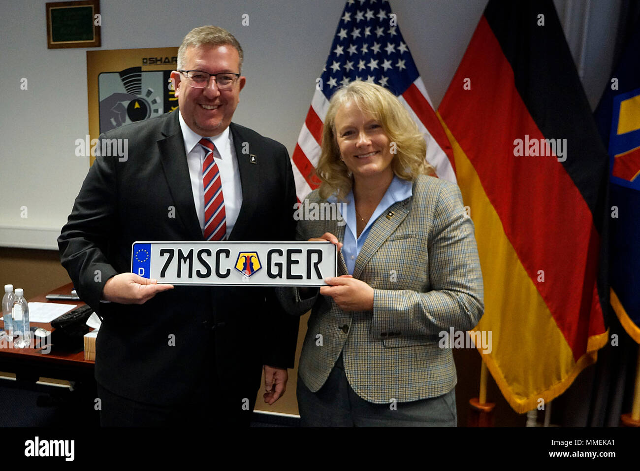 James Otto, 7th Mission Support Command chief executive officer, presents a commemorative ...