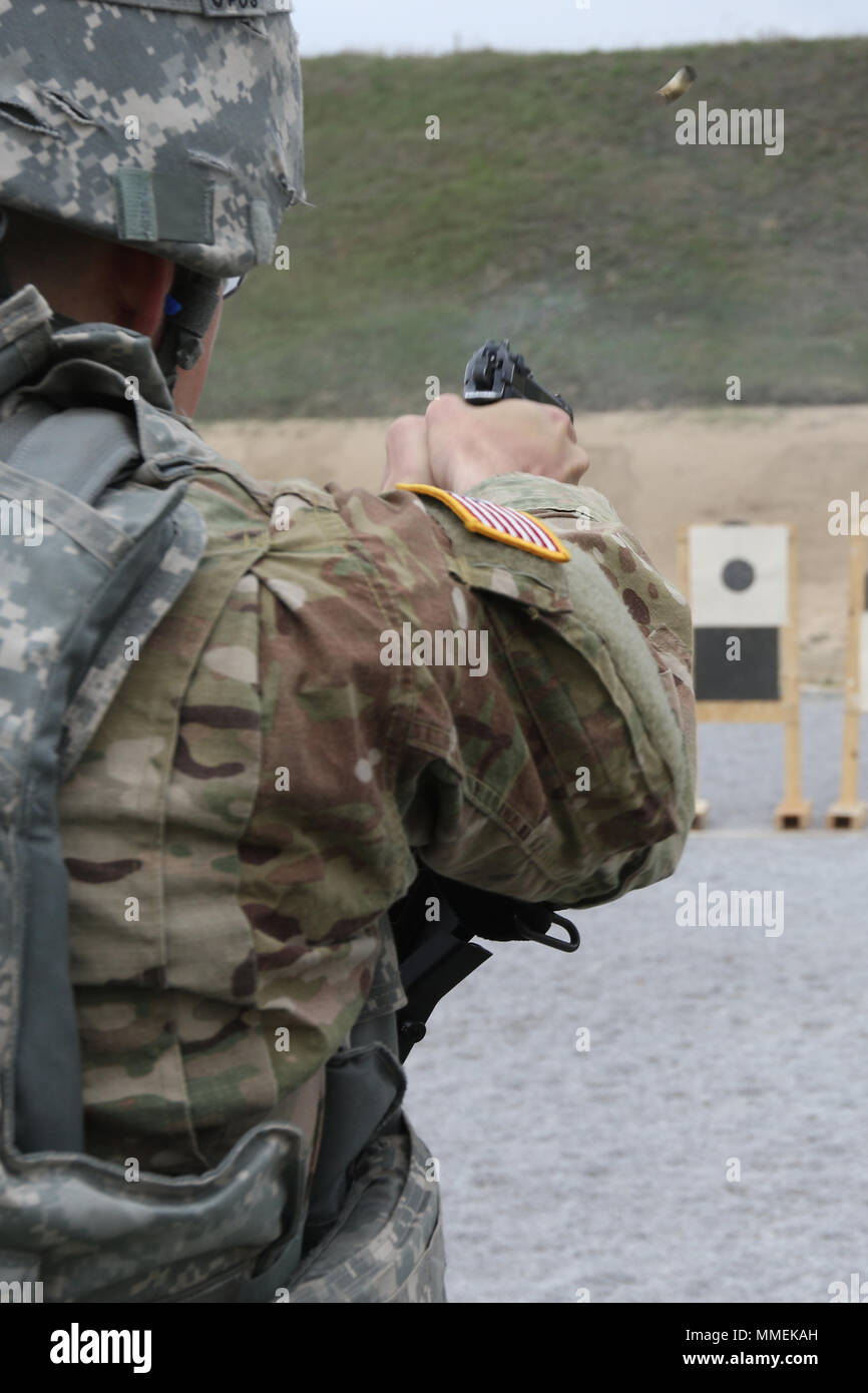 A Soldier fires the M9 pistol at a target during the range event of the ...