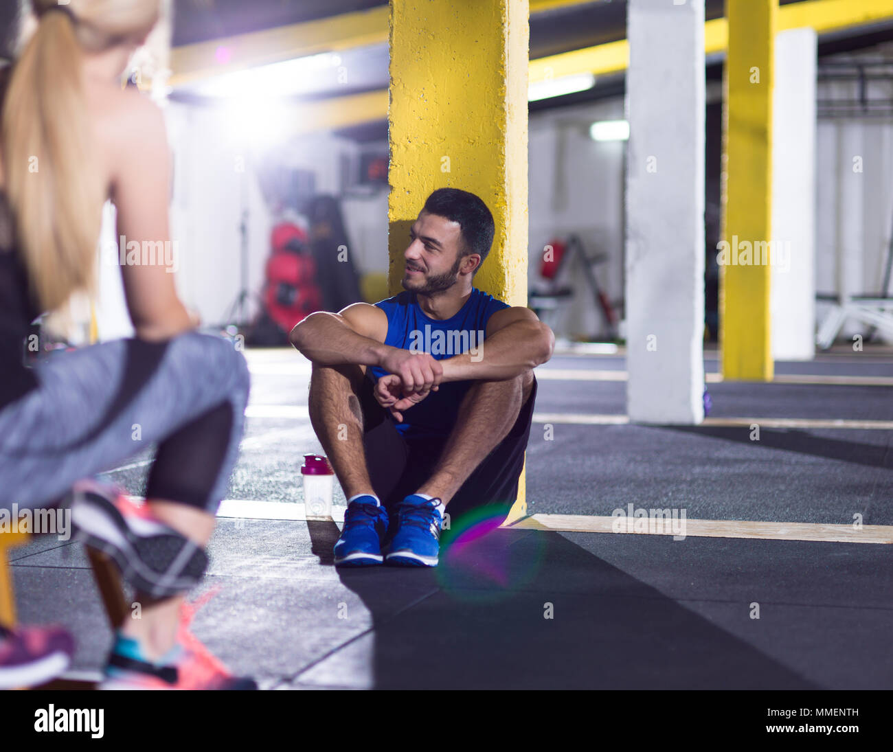 a group of young athletes sitting on the floor and relaxing after ...