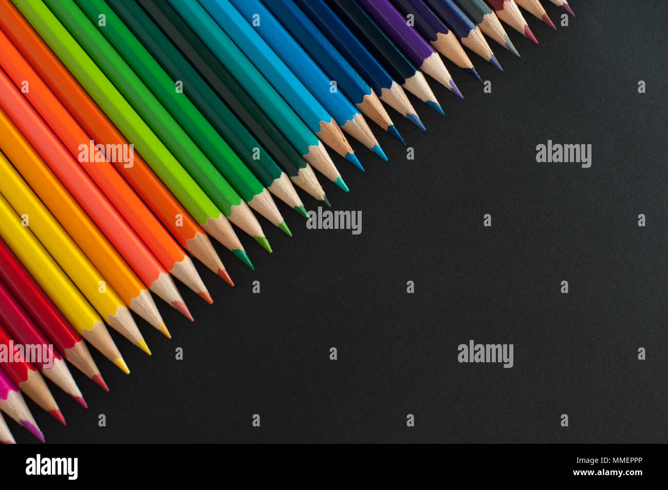 Colour pencils on black texture background Stock Photo - Alamy