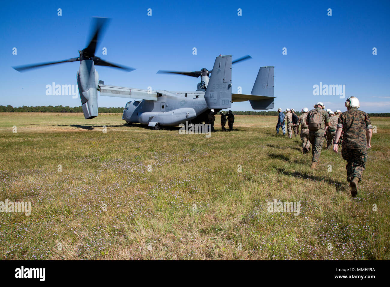 U.S. Marines, Sailors and distinguished guests board a MV-22 Osprey ...