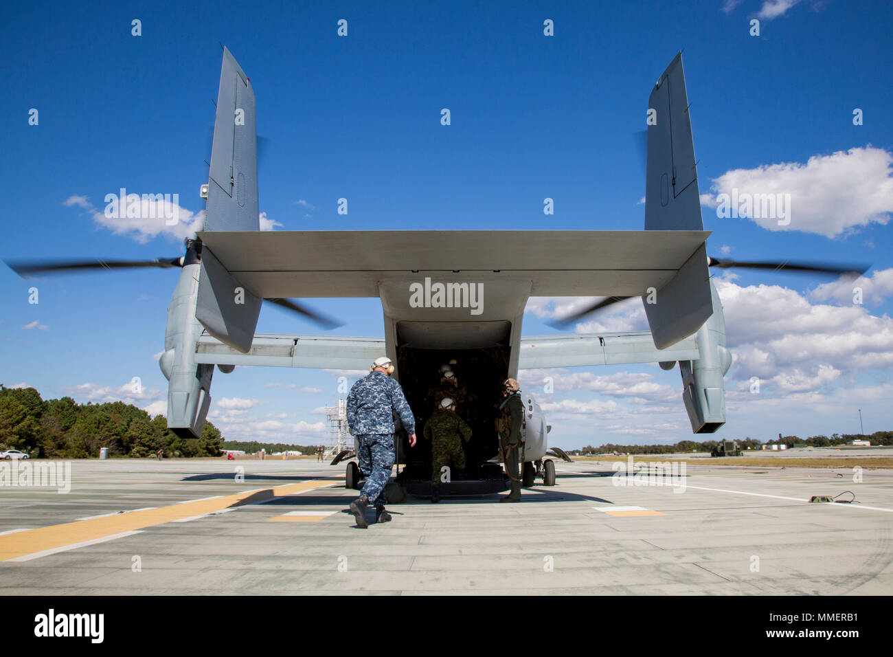 U.S. Marines, Sailors and distinguished guests board a MV-22 Osprey ...
