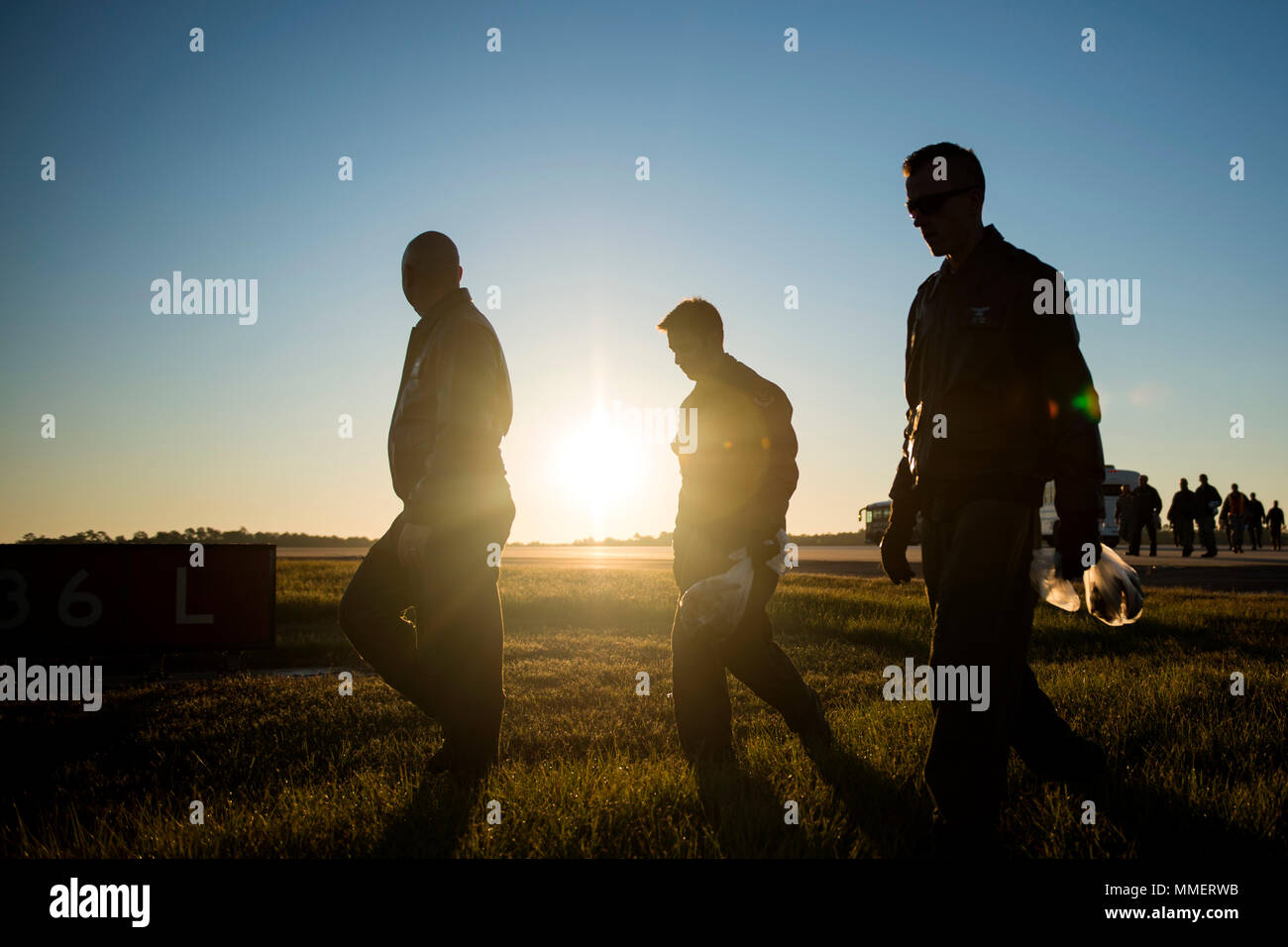 Airmen make their way onto the fields next to the flight line during a ...