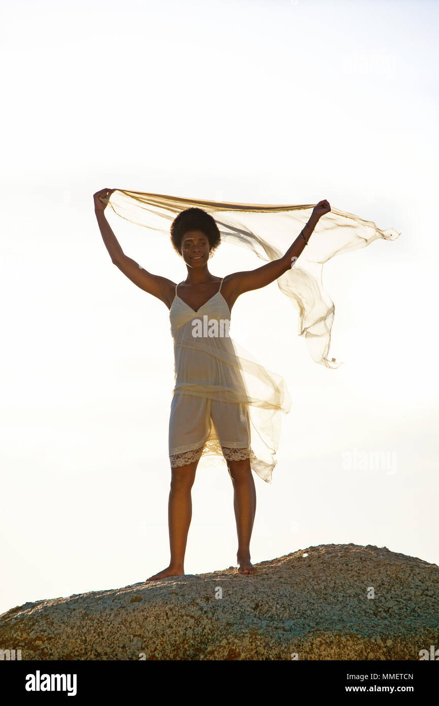 Young woman splashing in water on the beach hi-res stock photography ...