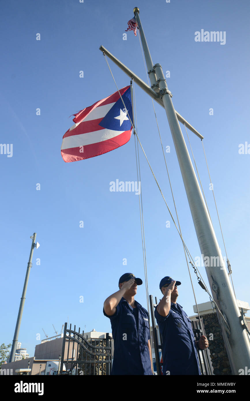 Two members of Coast Guard Sector San Juan, Puerto Rico, unfurl and ...